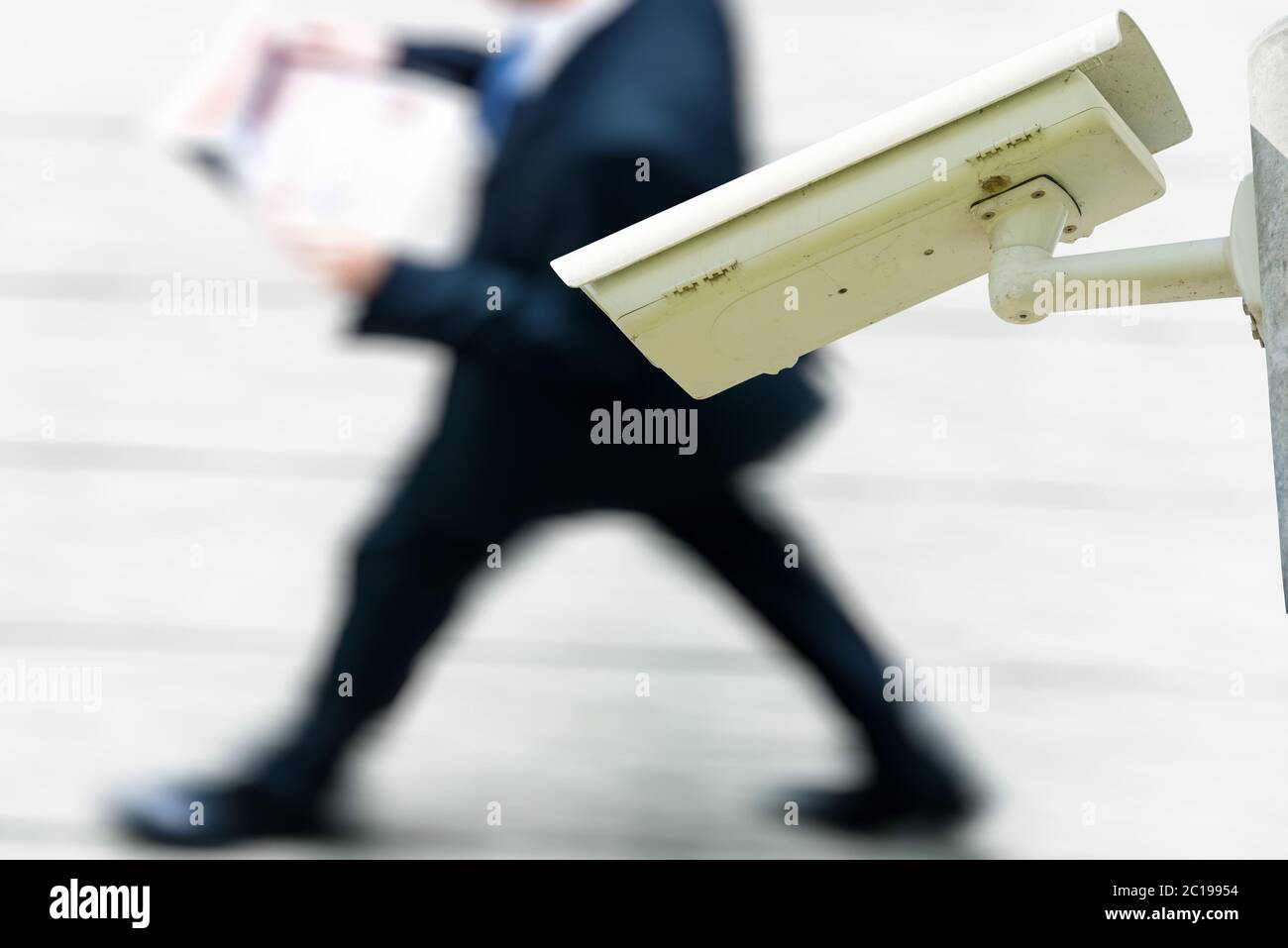 security CCTV camera or surveillance system with business man walking ...