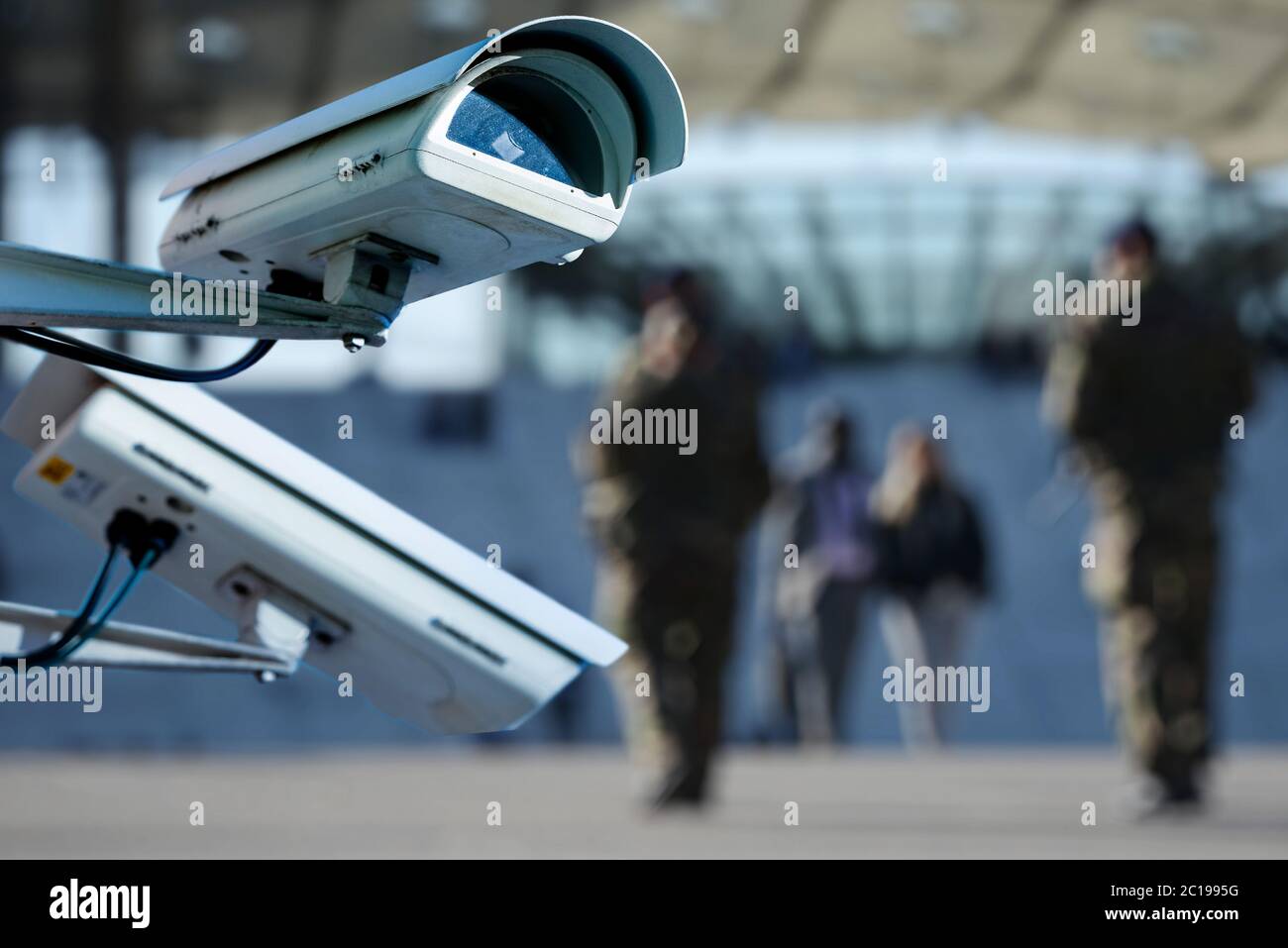 security CCTV camera or surveillance system with military on blurry ...