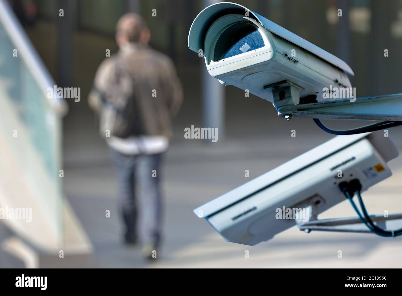 security CCTV camera or surveillance system with man on blurry ...