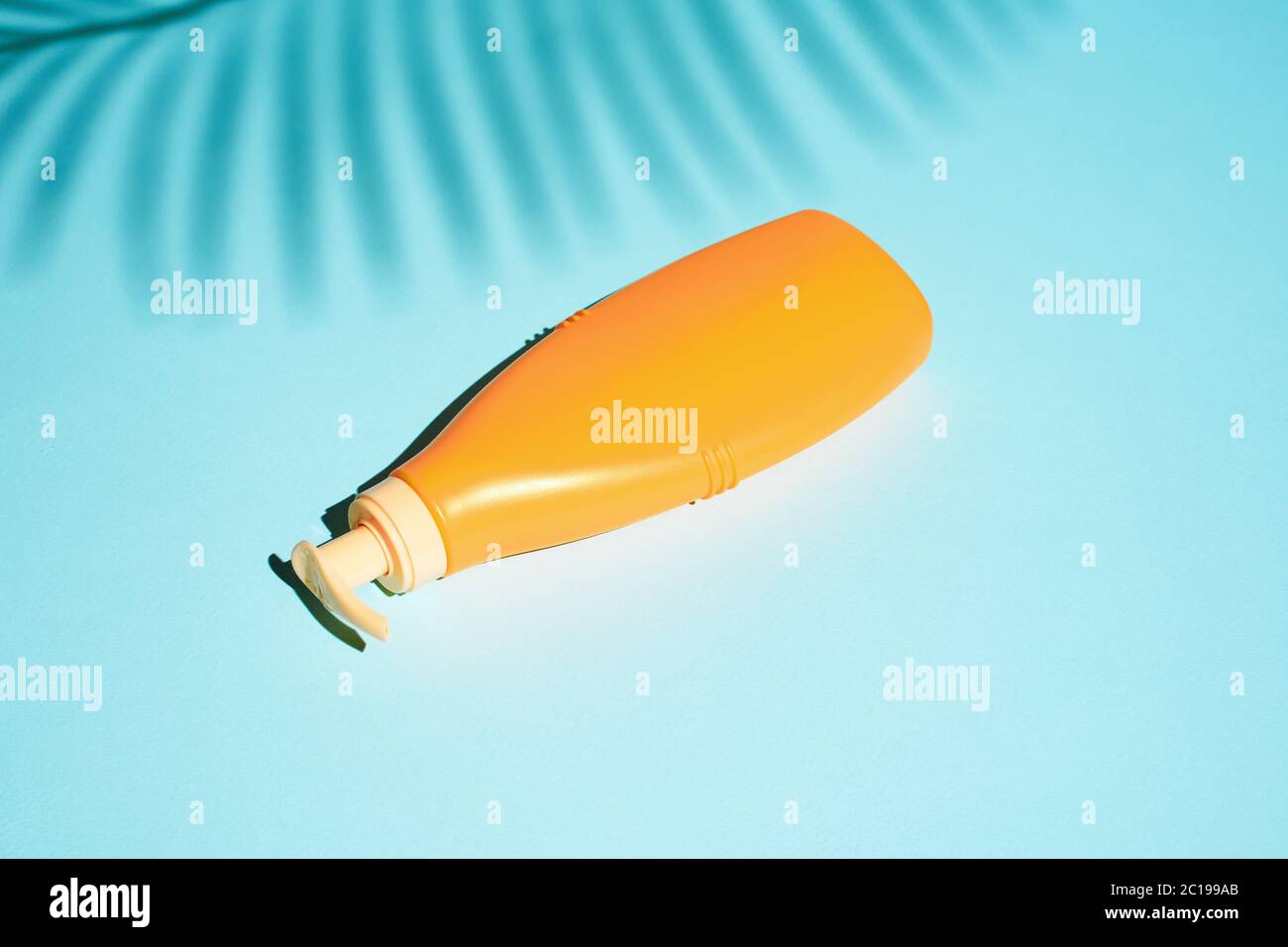 Orange container for cosmetics without label lies on blue background ...