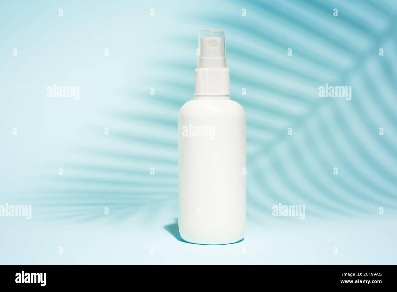 White container without label for spray on blue background, place for ...
