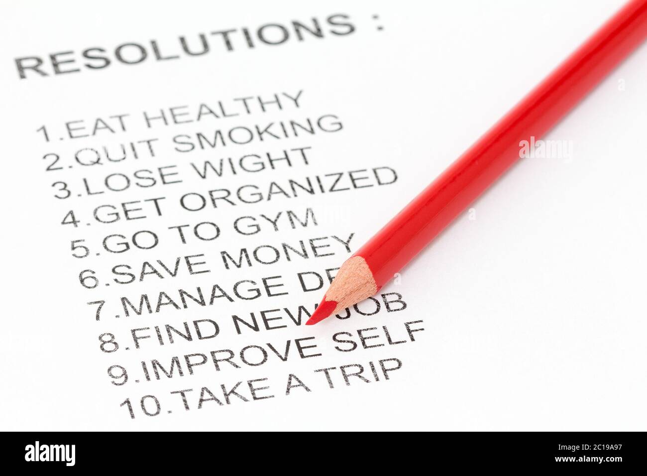 Red pencil and list of resolutions Stock Photo - Alamy