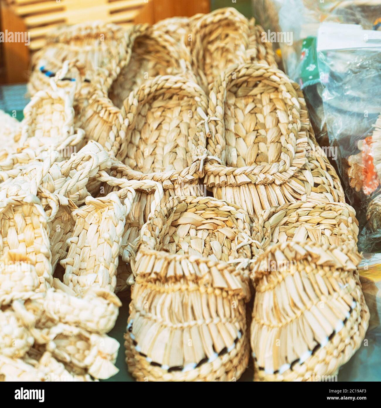 Souvenir bast shoes woven from bast. Old traditional Russian shoes ...