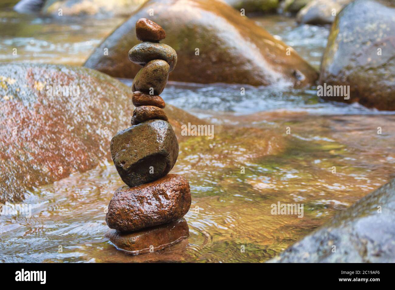 Zen in rock in the middle of a river stream in Sukabumi, West Java ...