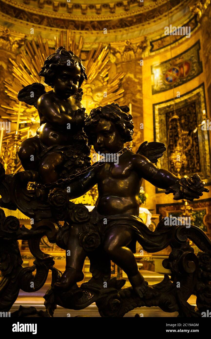 Bronze statue of two baby angels in a church in Rome, Italy Stock Photo ...