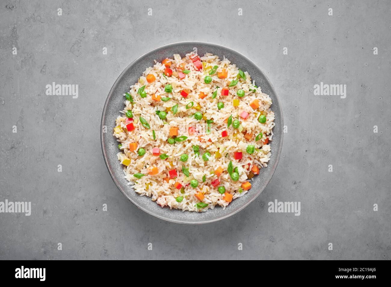 Veg Fried Rice in gray bowl on concrete table top. Veg Fried rice is ...