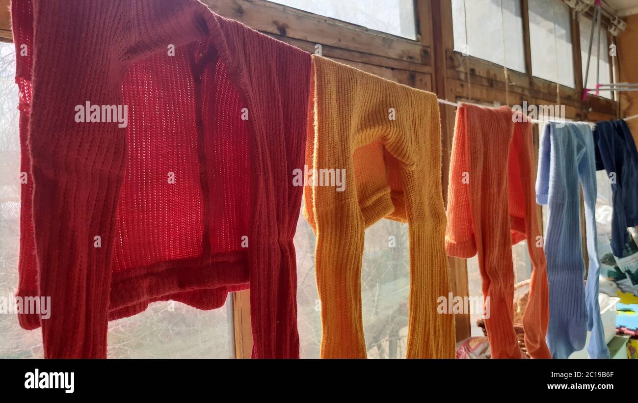 Infant Tights Kids drying on balcony after washing Stock Photo - Alamy