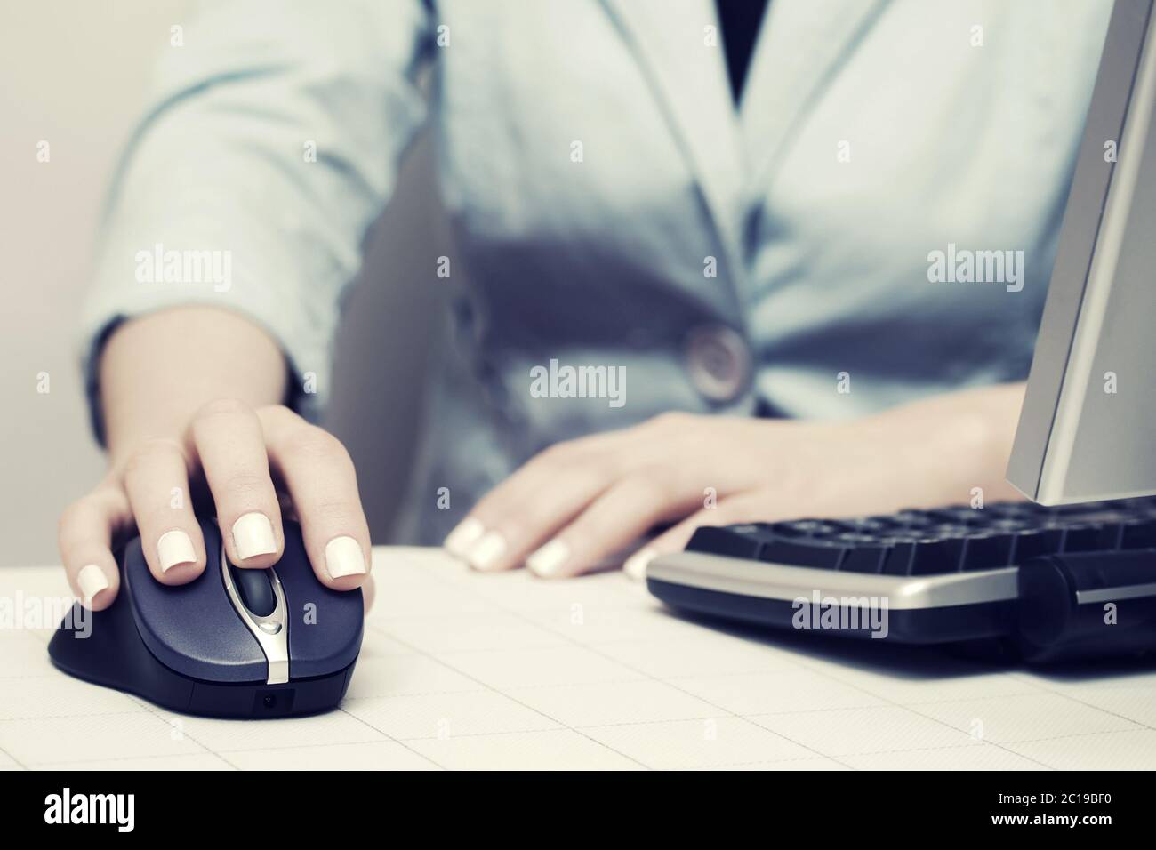 Business woman using computer mouse and keyboard Stock Photo - Alamy