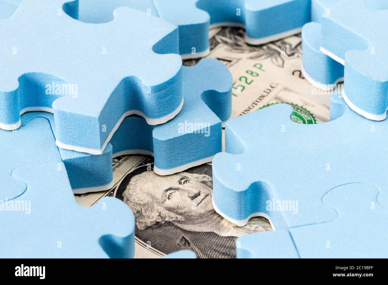 US dollar hidden under puzzle Stock Photo - Alamy