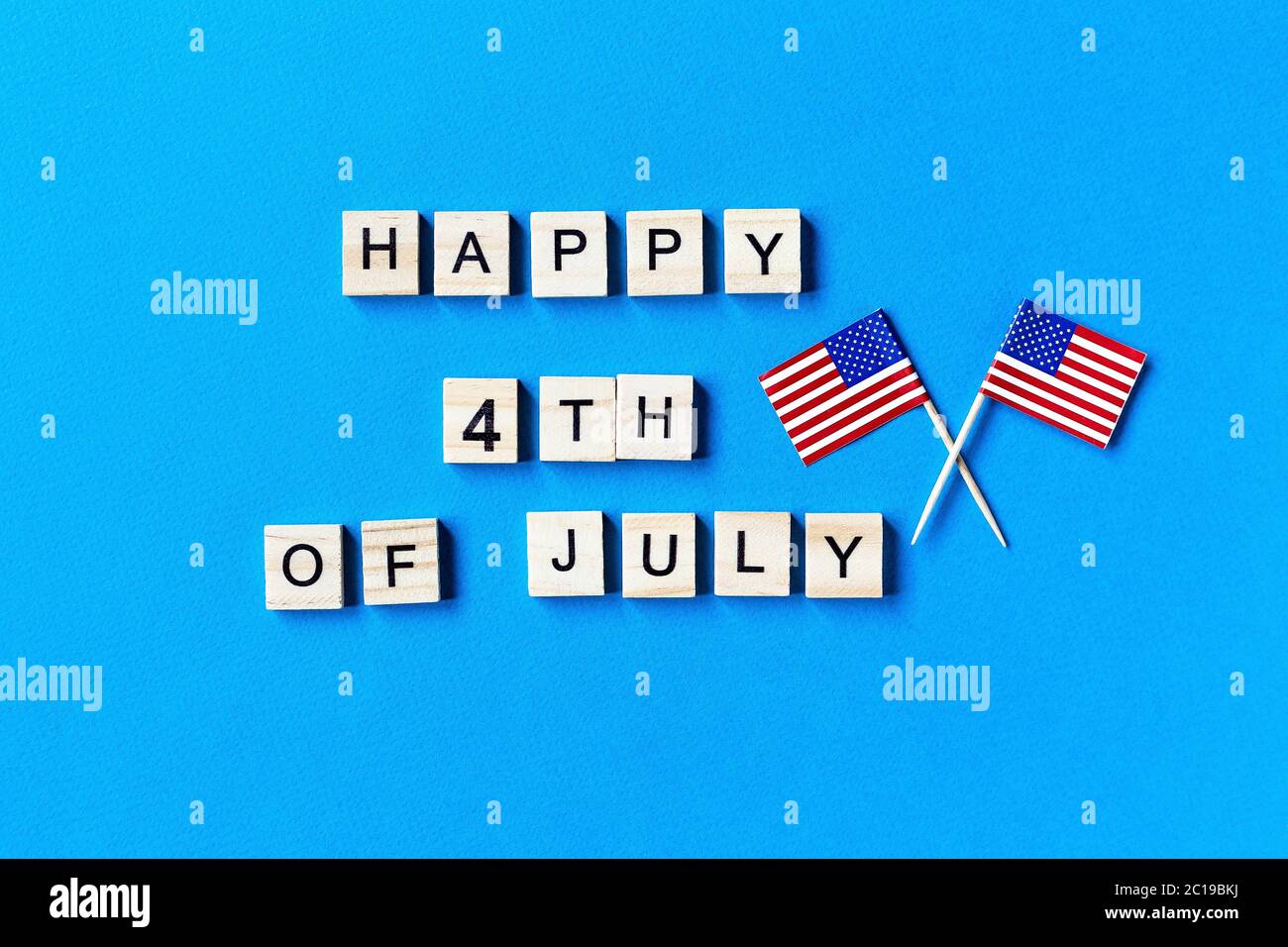 the inscription July 4 in wooden letters on a blue background. Design ...