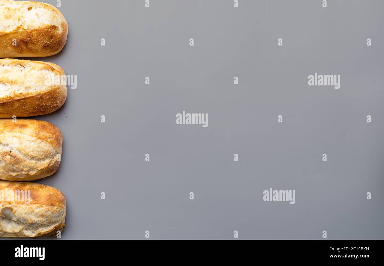 French bread rolls in a row on grey background with copy space Stock ...