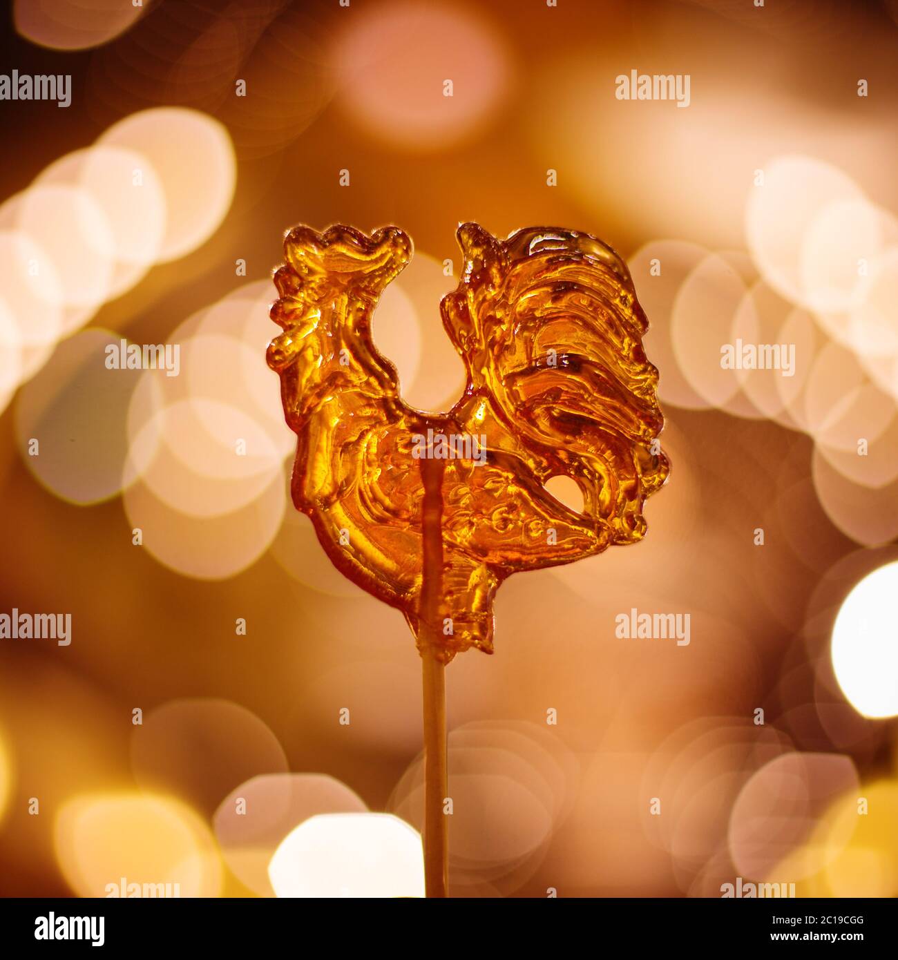 Cockerel candy on a stick. Hard candy rooster. Rooster candy symbol ...