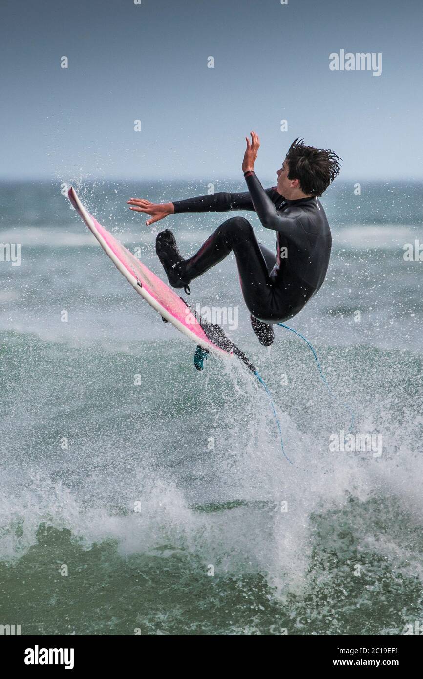 Spectacular action as a surfer gets in the air from a wave at Fistral ...
