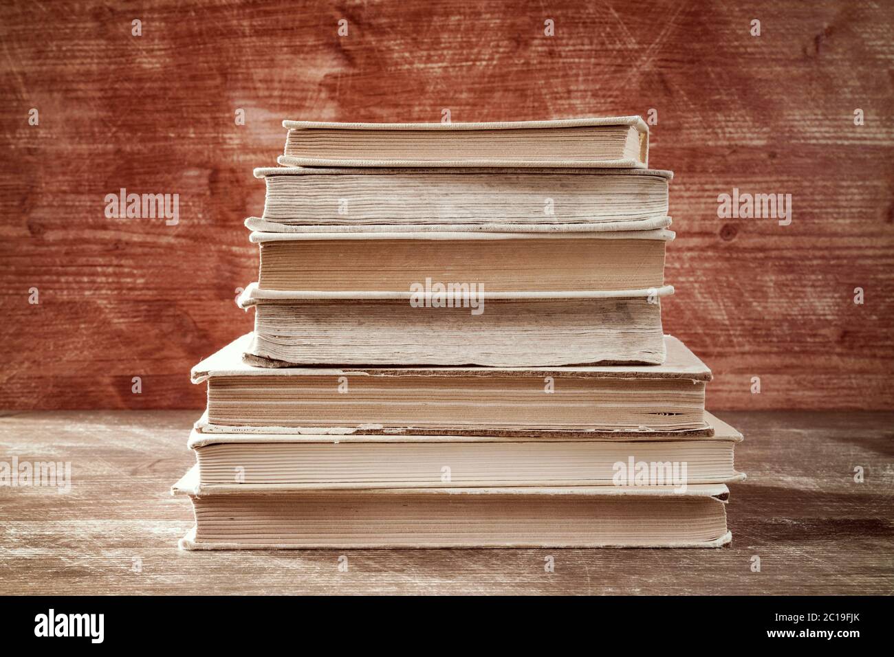 Pile of books on wooden background Stock Photo - Alamy