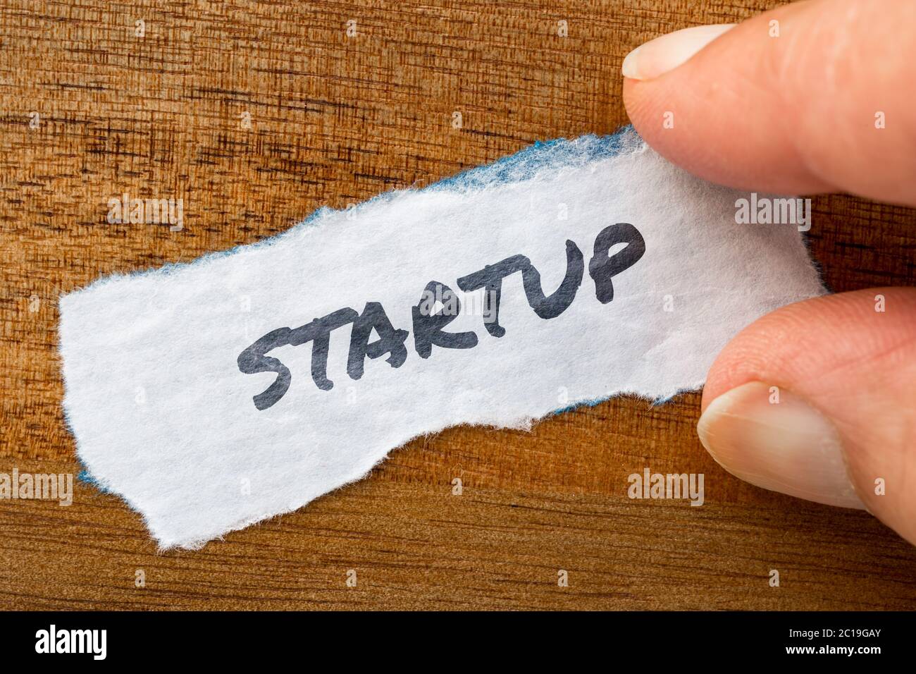 Start up concept and theme written on old paper on a grunge background ...