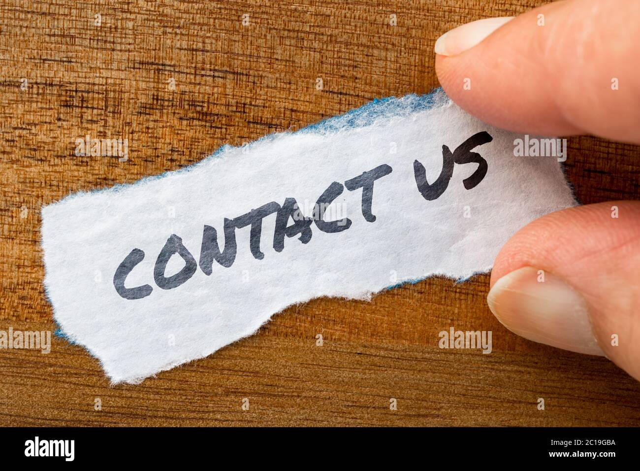 Contact us concept and theme written on old paper on a grunge ...