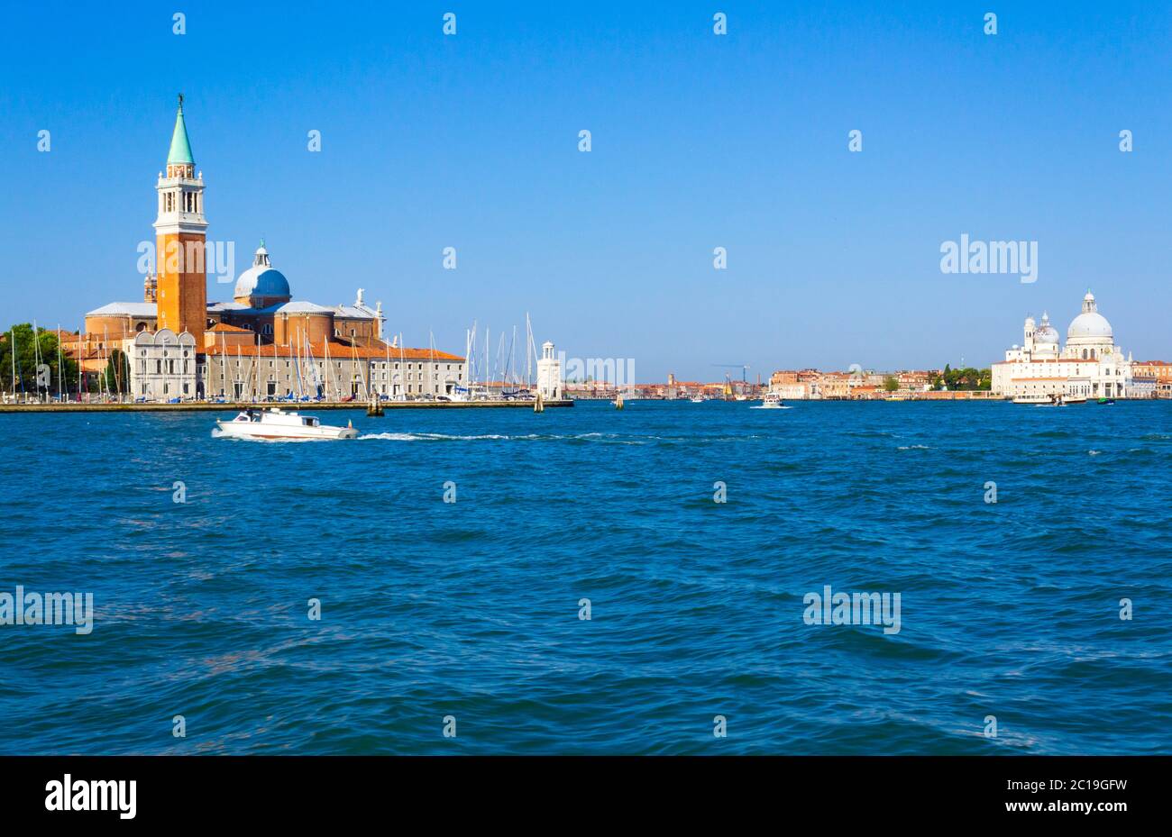 Summertime view of Venice cityscape,lagoon with tour boats navigating ...
