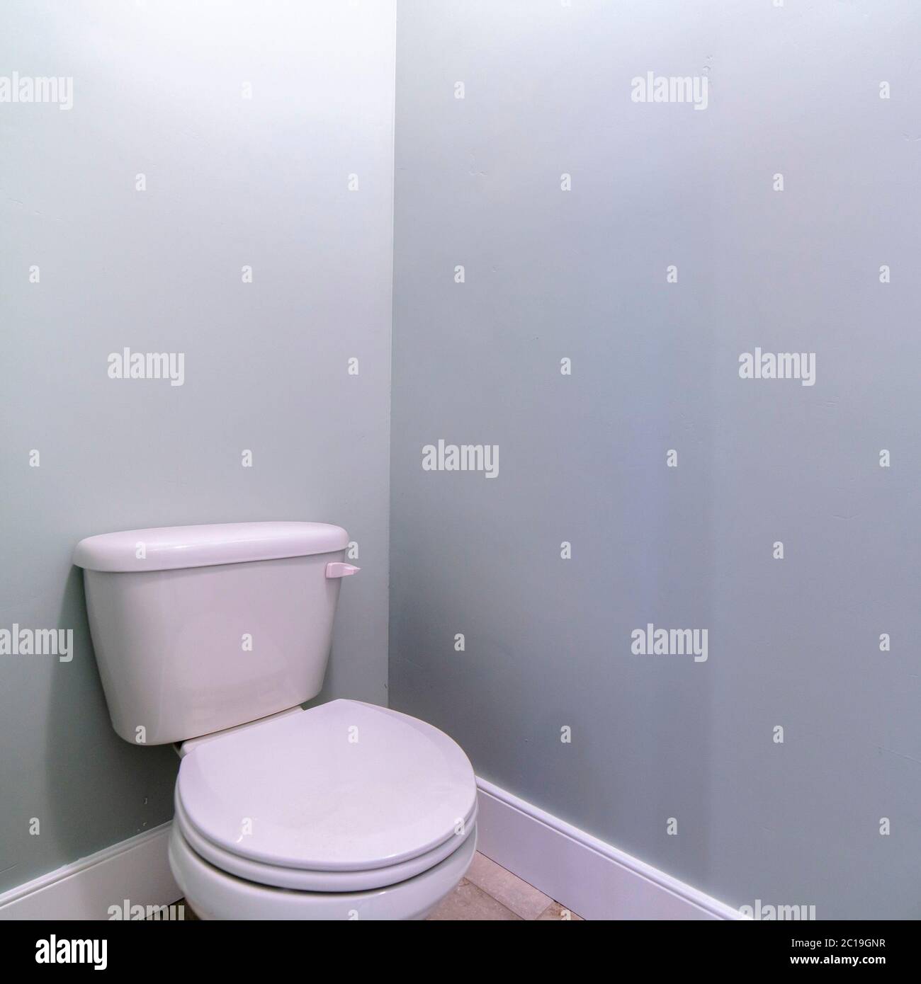 Square Closed toilet and cistern in a small lavatory Stock Photo - Alamy