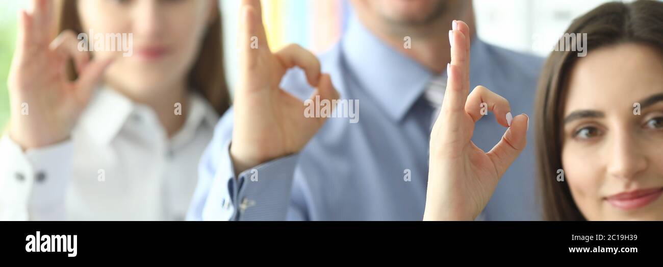 Team showing okay sign Stock Photo - Alamy