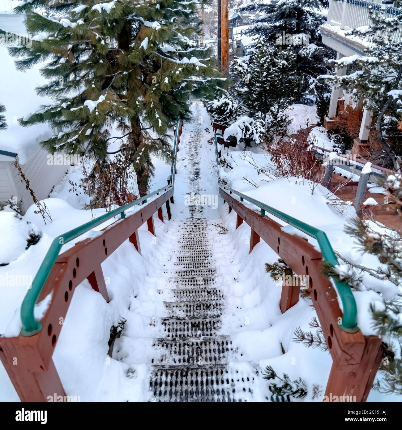 Square Stairs amid neighborhood and scenic hill blanketed with white ...