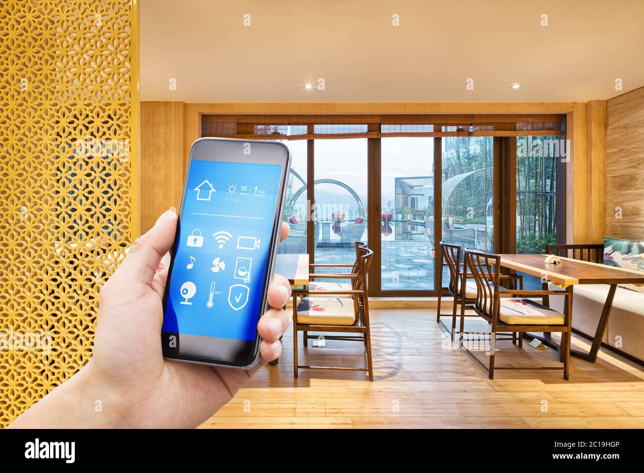 smart phone with smart home with modern dining room Stock Photo - Alamy