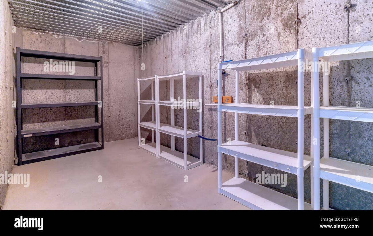 Panorama Empty multi layer metal racks inside a storage room with ...