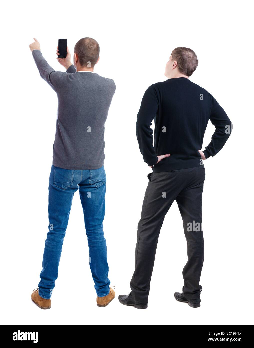 Back view of two man in sweater with mobile phone. Rear view people ...