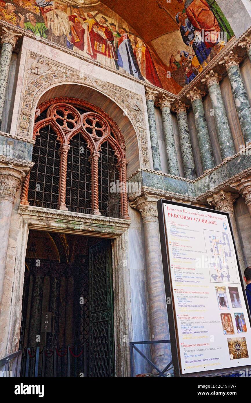 One of the five round-arched portals, enveloped by polychrome marble ...