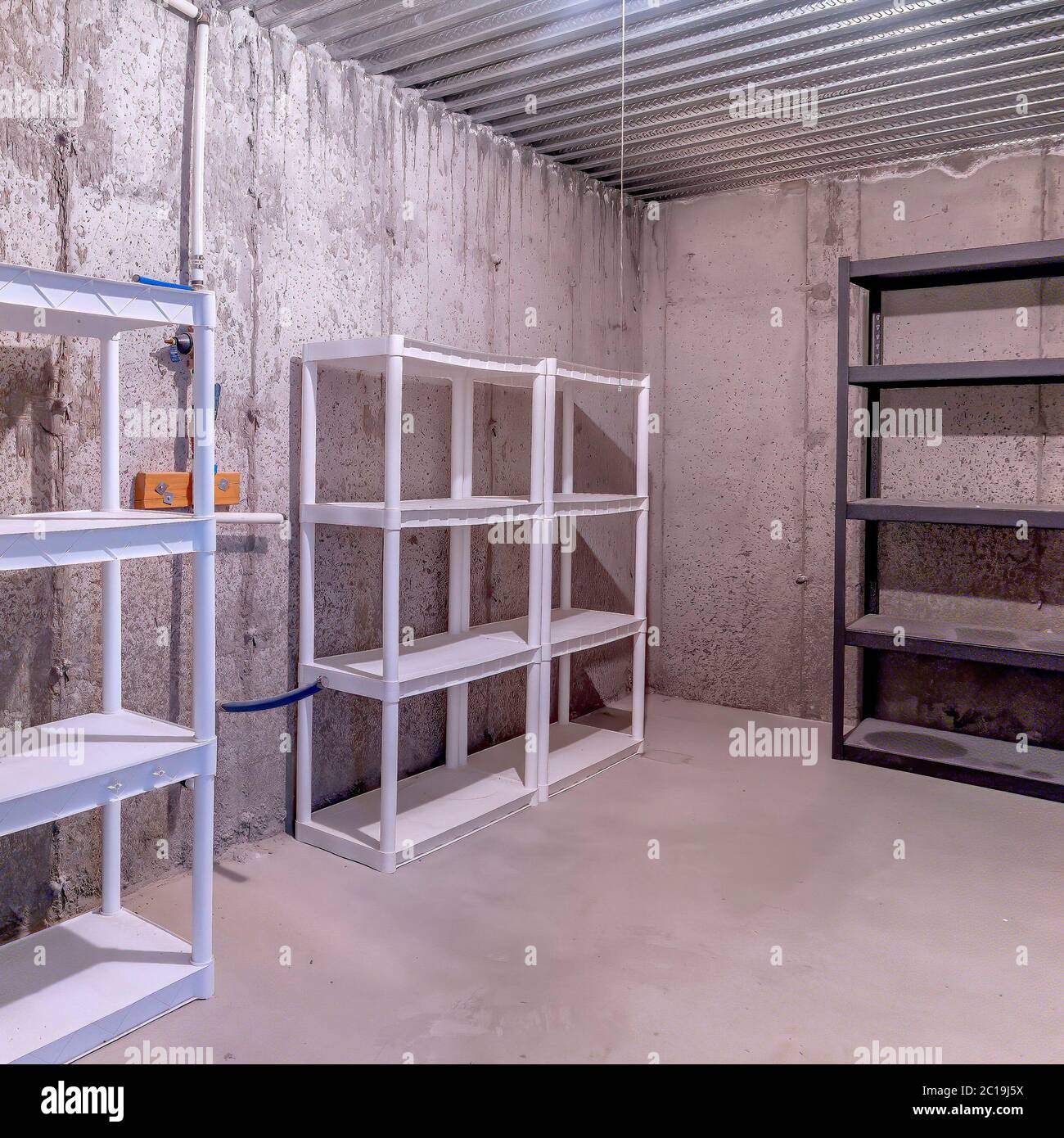 Square crop Empty multi layer metal racks inside a storage room with ...
