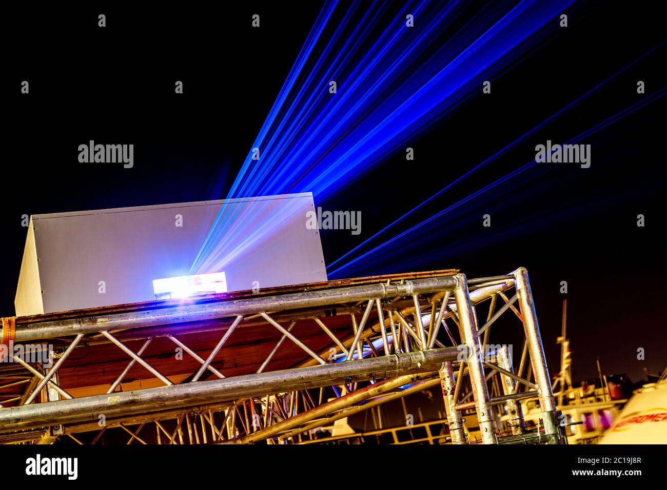 laser projection device with long blue rays projected into the night ...