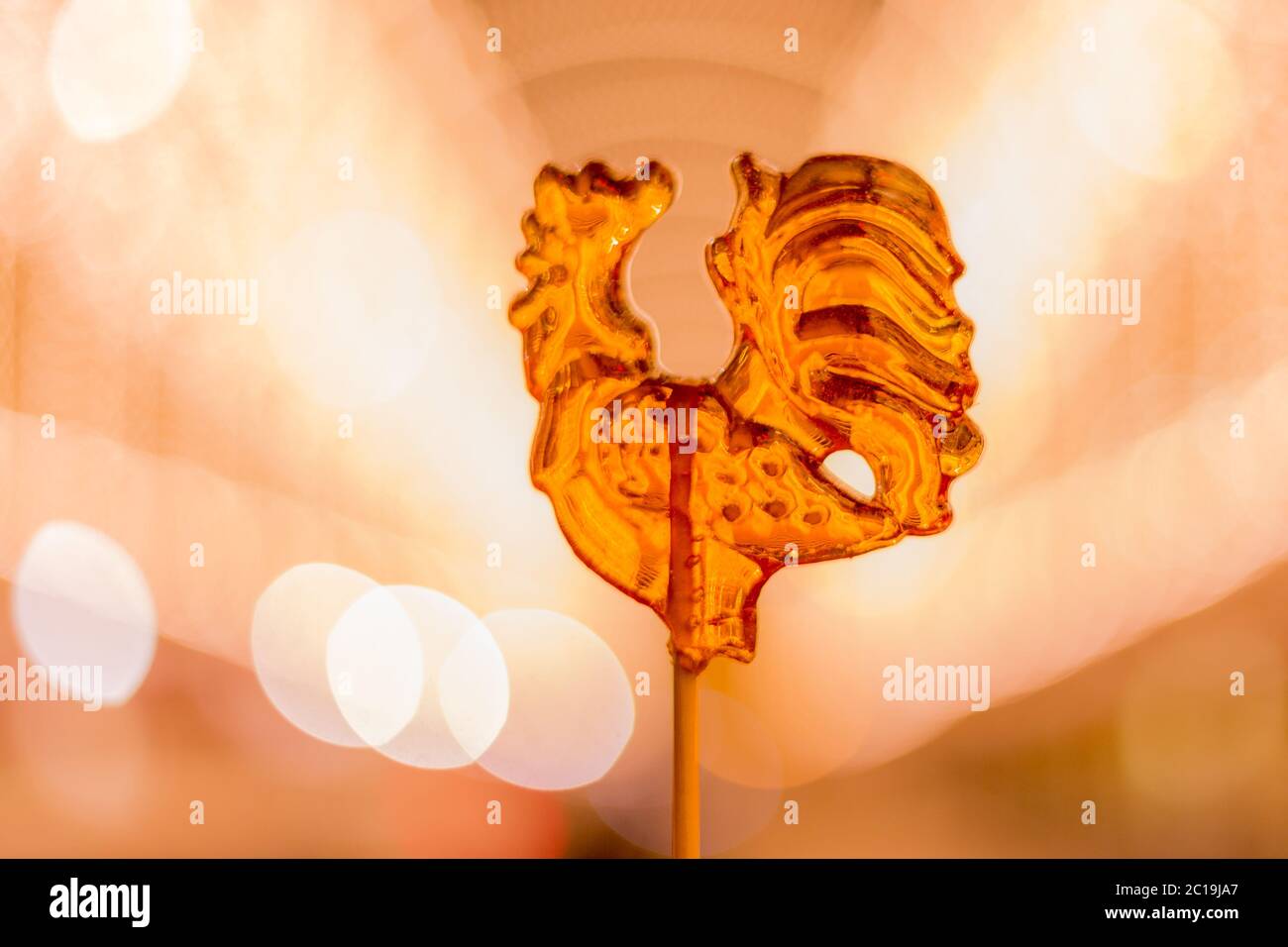 Cockerel candy on a stick. Hard candy rooster. Rooster candy symbol ...