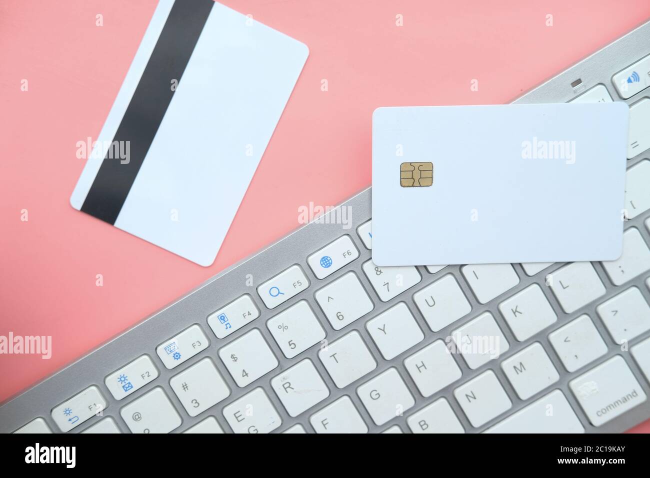 shopping online payment. Card on keyboard on pink desk Stock Photo - Alamy
