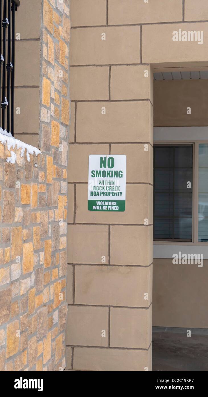 Vertical Exterior view of apartments with No Smoking sign on the stone ...