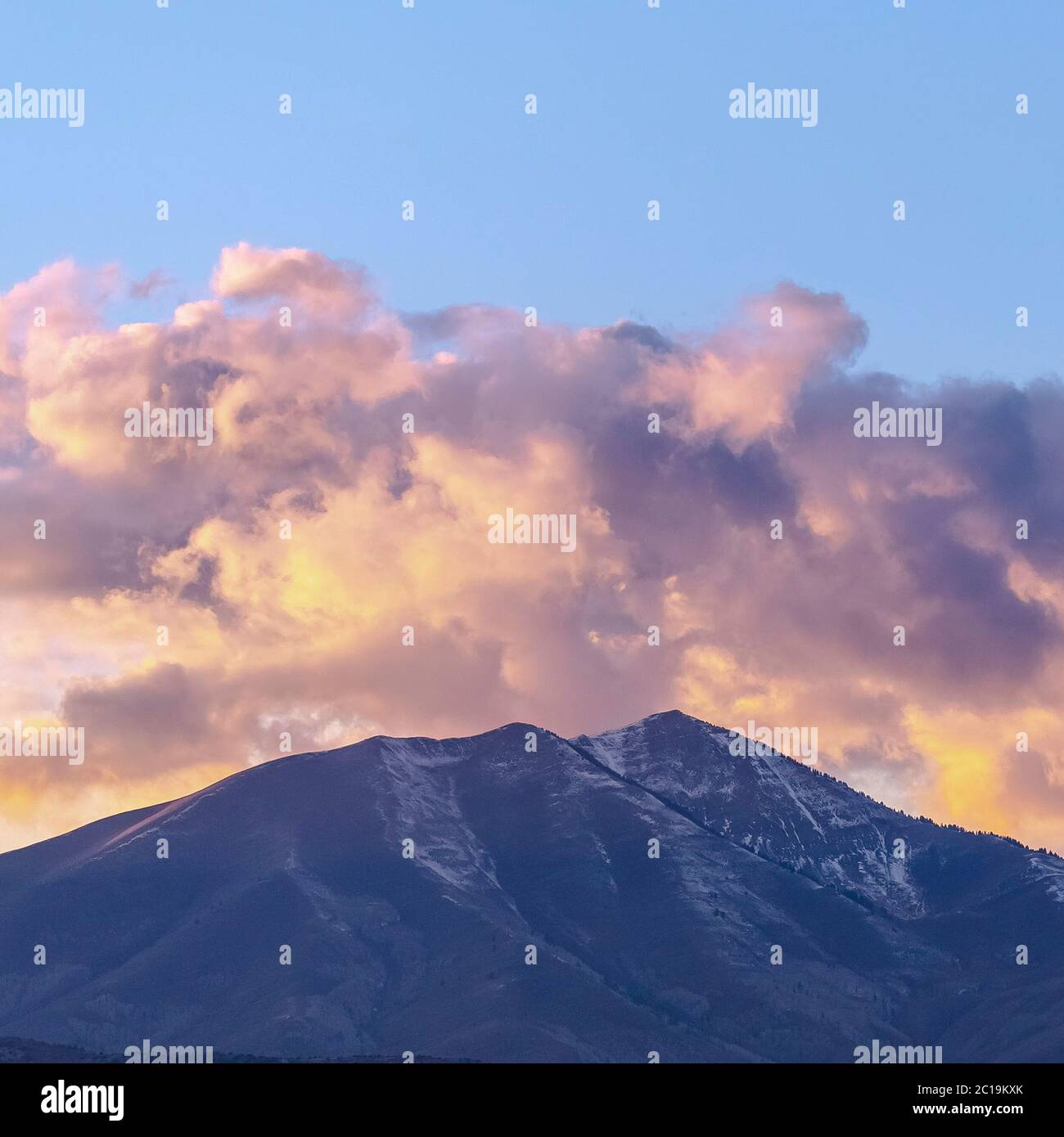 Square Clouds gathering over the mountain at sunset Stock Photo - Alamy