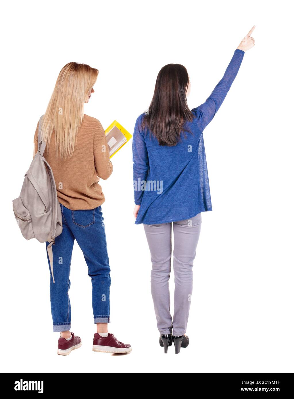 Back view of two pointing girl in sweater. Rear view people collection ...