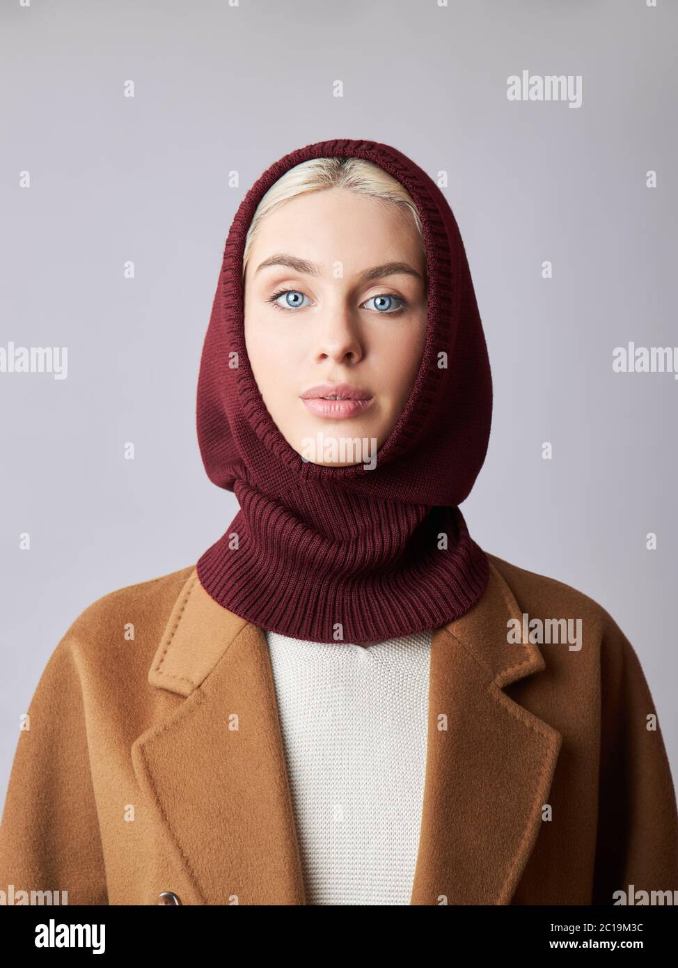 European Muslim woman with a blonde hair in a bonnet hood dressed on ...