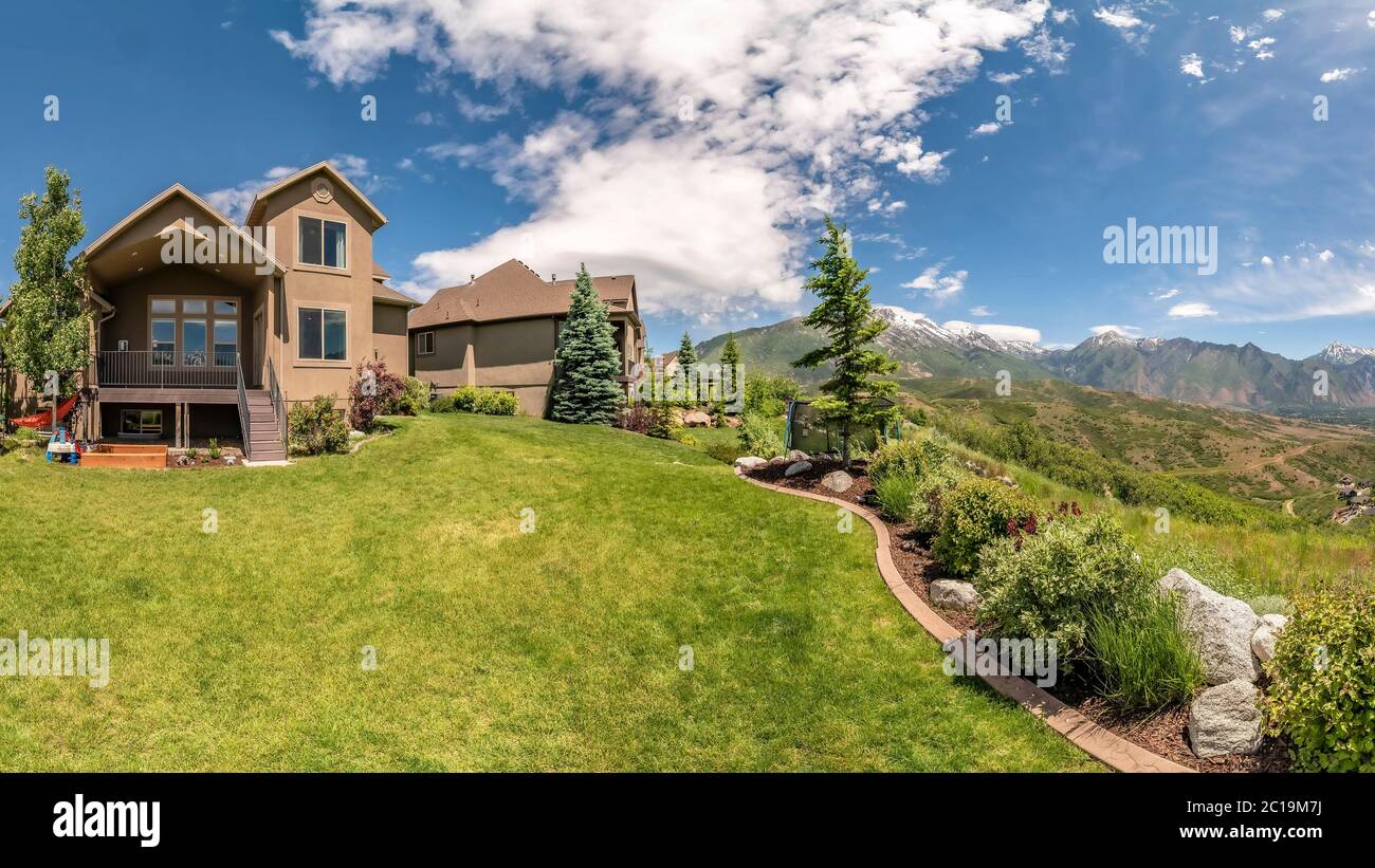Panorama frame Panorama of the backyard of home with landscaped grassy ...