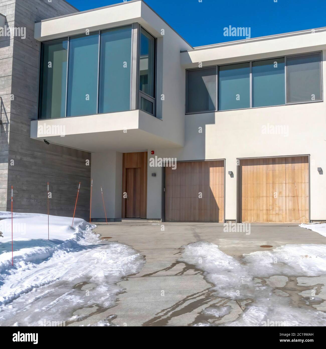 Square frame Facade of a modern home on a snowy hill neighborhood in ...