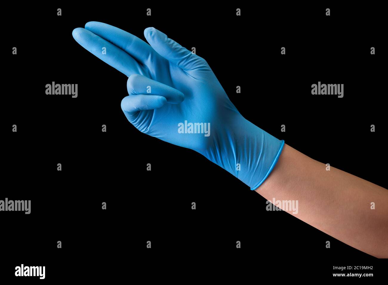 Doctor's hand in medical gloves showing two fingers up in peace symbol ...