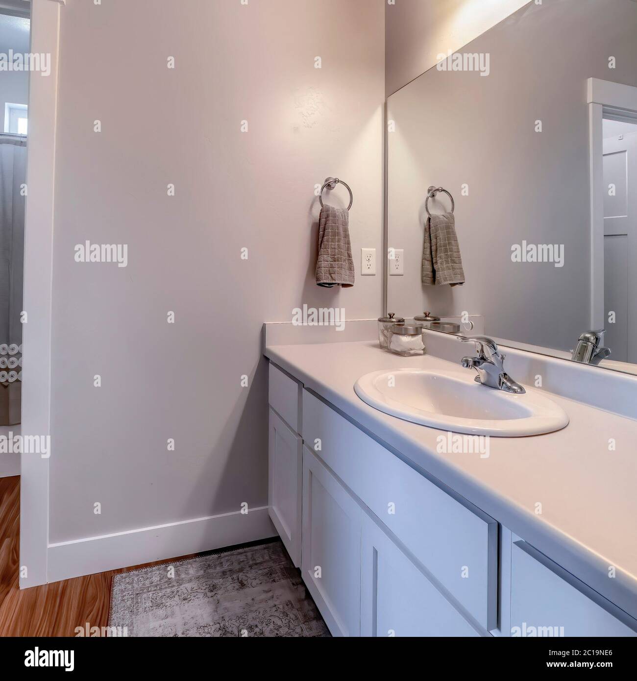 Square Vanity area of bathroom with door that leads to the toilet ...