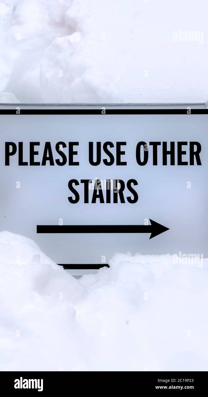 Vertical Sign that reads Please Use Other Stairs against fresh white ...