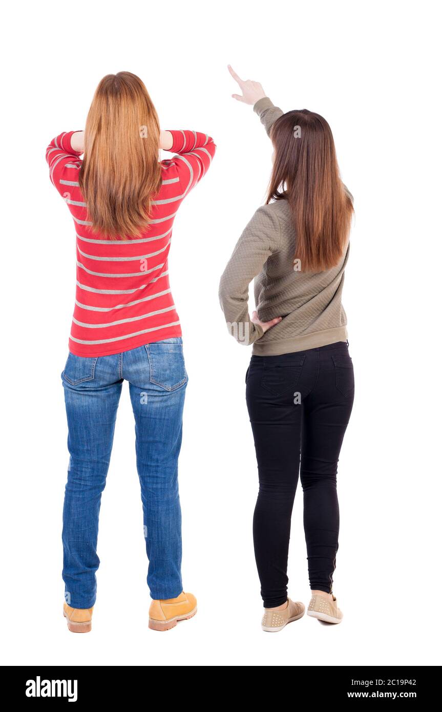 Back view of two pointing girl in sweater. Rear view people collection ...