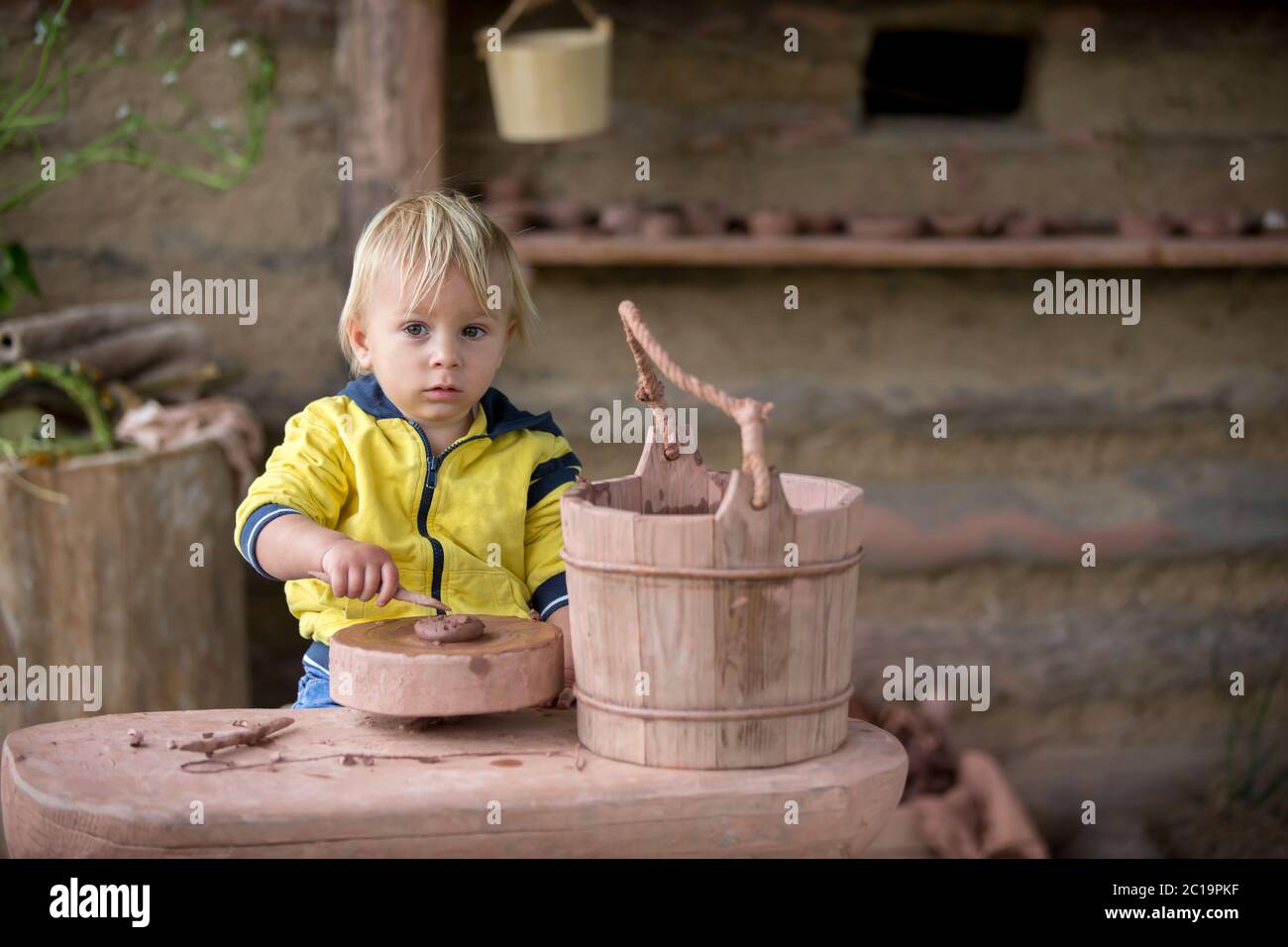 Child, cute boy, making ceramic pot on a farm Stock Photo - Alamy