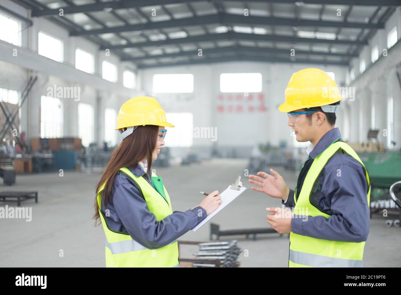 young asian man and woman work in workshop Stock Photo - Alamy