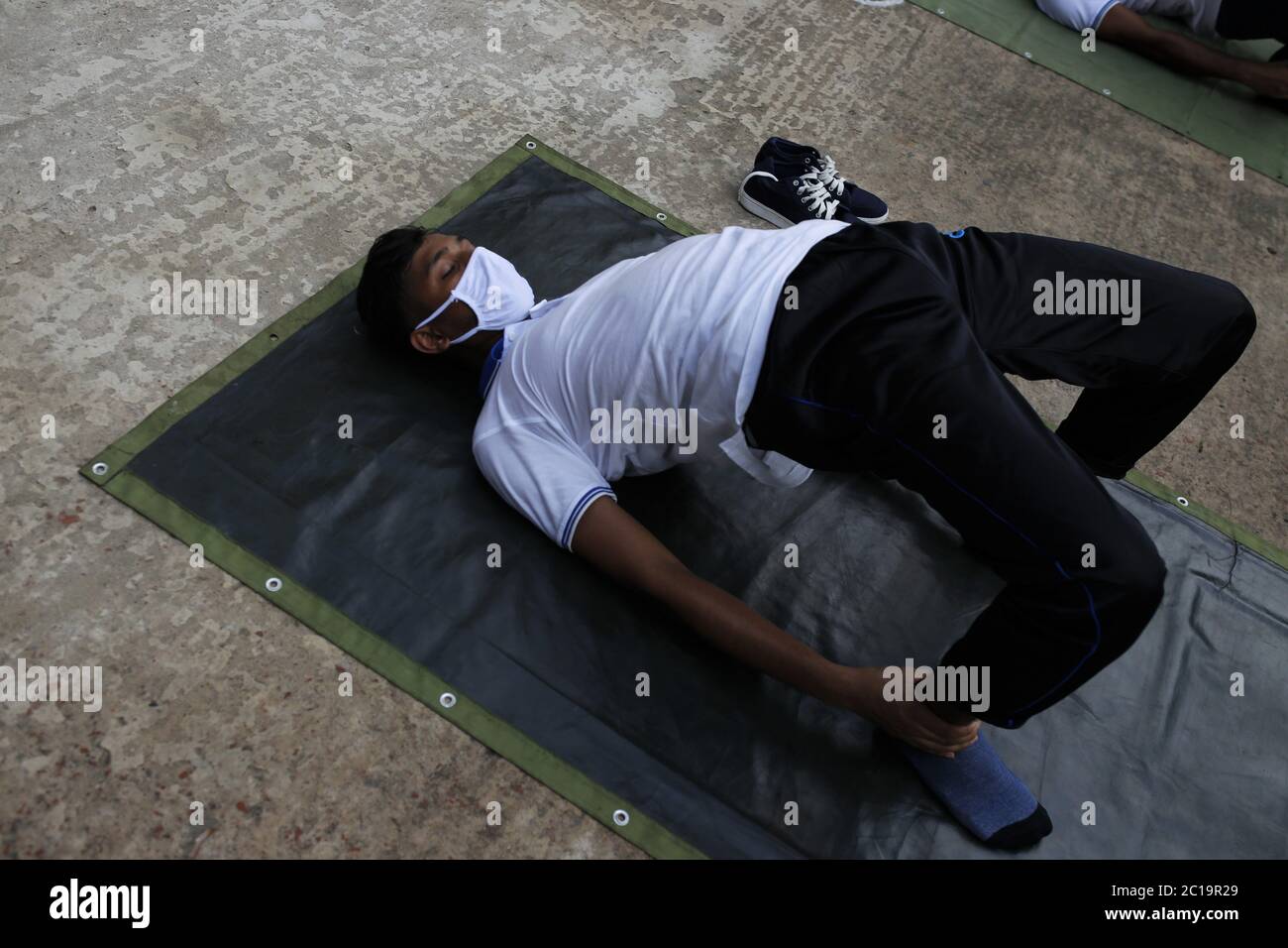 Dhaka, Bangladesh. 15th June, 2020. A police persona attends a yoga ...