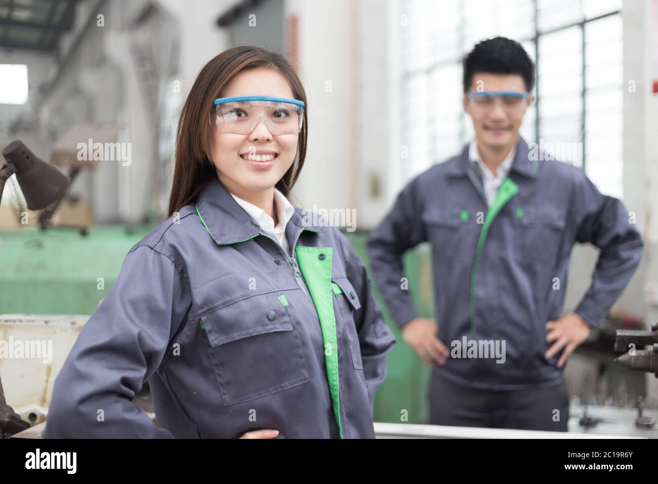 young asian man and woman work in workshop Stock Photo - Alamy