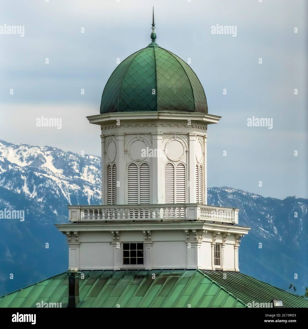 Square Building exterior with green dome and roof against snowy ...