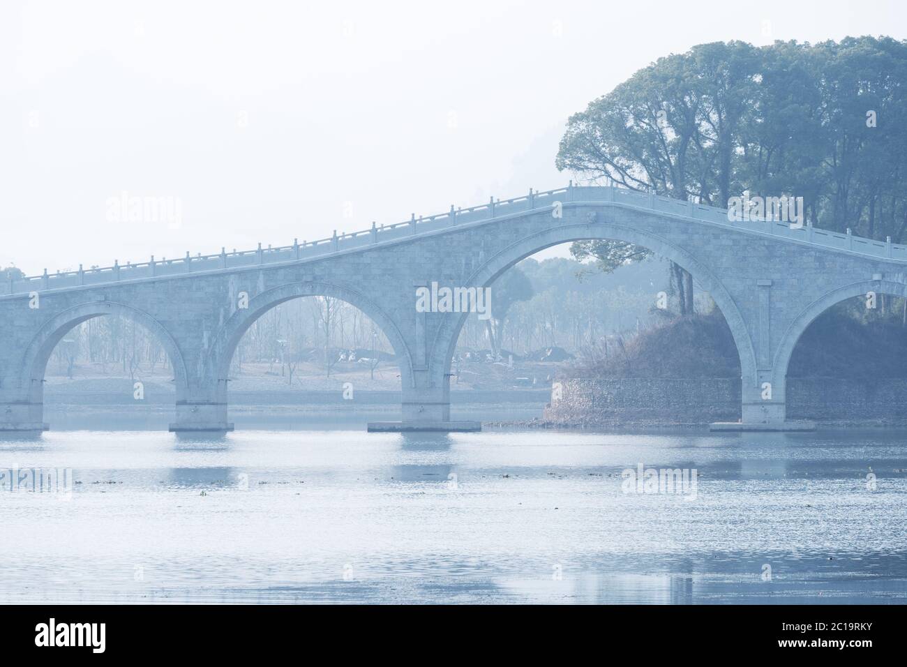 rock arch bridge over tranquil lake Stock Photo - Alamy