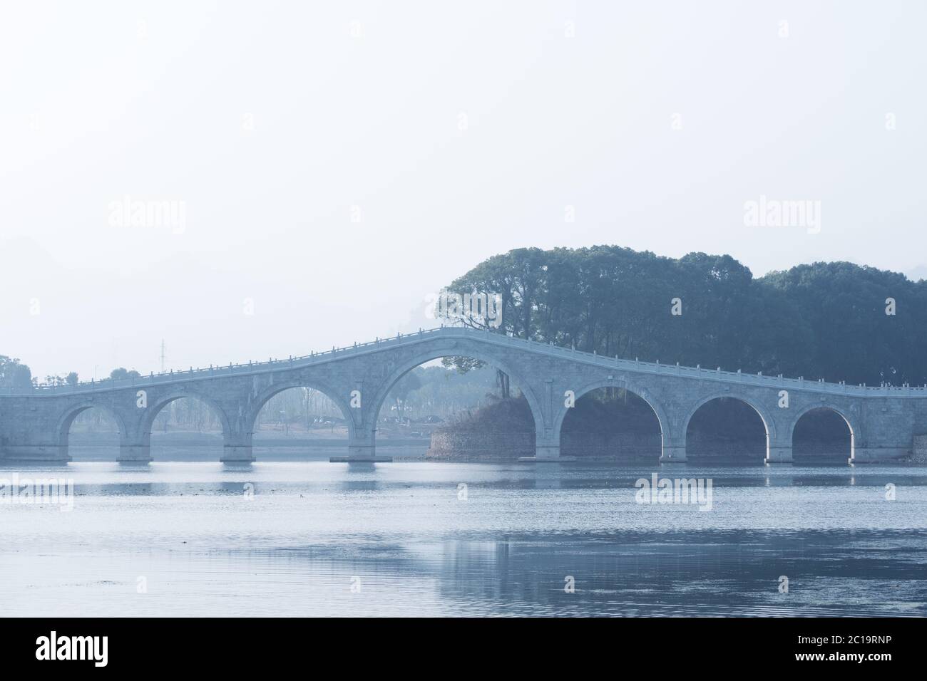 rock arch bridge over tranquil lake Stock Photo - Alamy