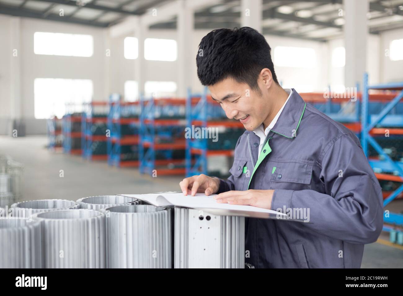 young asian man works in workshop Stock Photo - Alamy